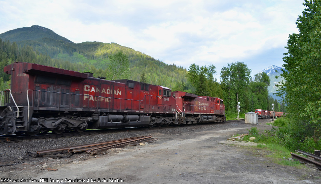 CP 8145/8646 lead a E/B unit stack train through the Taft Road crossing towards CP 8165/8847, a ...